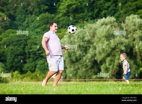 Father And Son Playing Football Stock Photo Alamy
