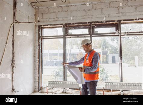 The Foreman At The Construction Site Is Carefully Studying The Project