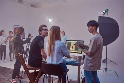 Guy Writing Notes Of Producers Near Photographer Stock Image Image Of
