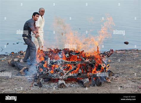 Cremation Fire At The Bank Of Holy Ganges River Varanasi India Stock