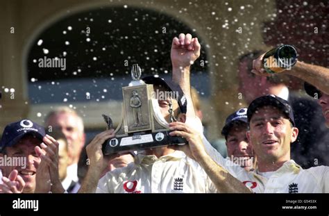Sport Cricket Celebrating Arms Raised Kissing Trophy Spraying Champagne
