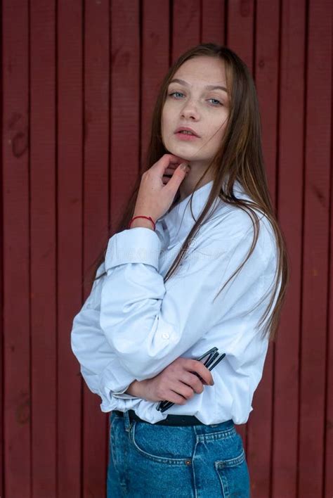 Una Chica Posando Con Un Fondo Rojo Una Joven Modelo Con Una Camisa