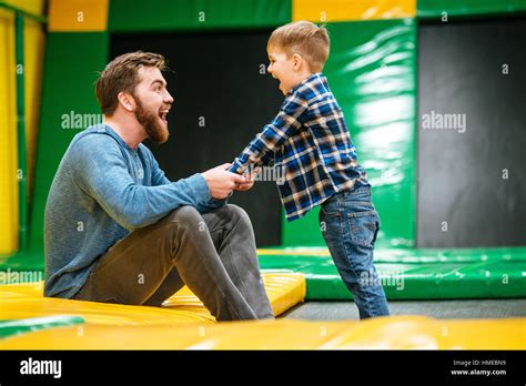 Cheerful Dad And Son Having Fun And Playing Together At Indoor