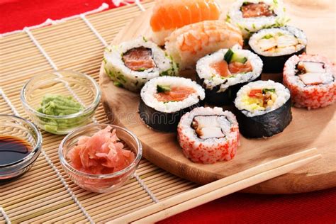 Composition With Assorted Sushi Rolls And Bowls Of Spices Stock Image