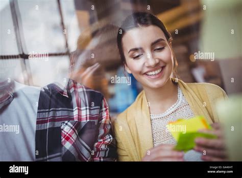 Businesswoman Smiling While Reading Sticky Notes Stock Photo Alamy