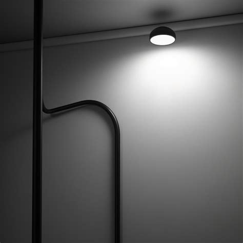Premium Photo The Black Lamp Is Facing Down Against A Wall