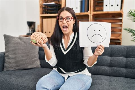 Young Hispanic Woman Working On Depression Holding Sad Emotion Paper