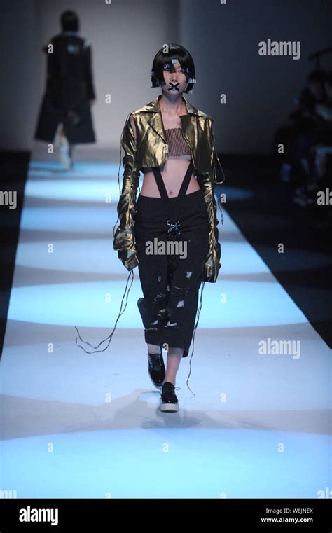 a model displays a new creation at the zhang yuhao fashion show during