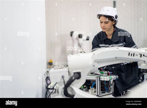 Engineers Maintenance Robot Arm At Lab In A High Tech Research