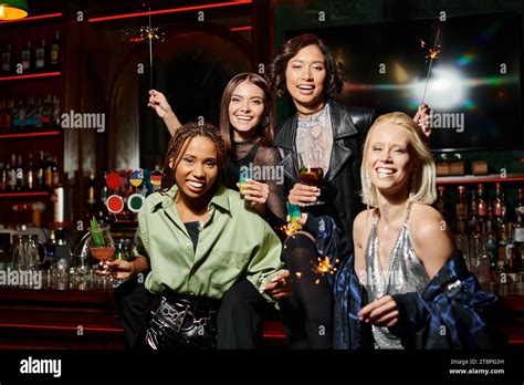 Cheerful Stylish Multiracial Girlfriends With Cocktails And Shiny