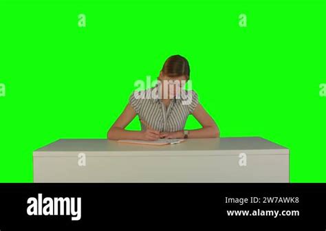 Young Girl Sitting In Classroom At Lecture And Listening Teacher On A Green Screen Stock Video