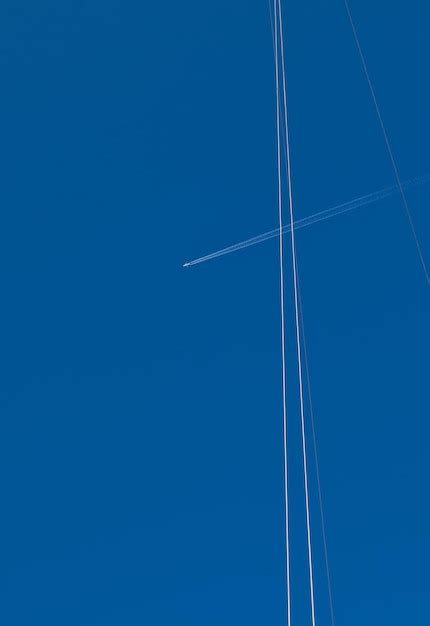 Premium Photo White Airplane Trace And Wires On Blue Sky