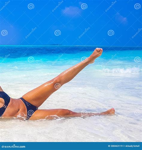 Beautiful Female Legs On Beach Sand In Water Maldives Stock Image