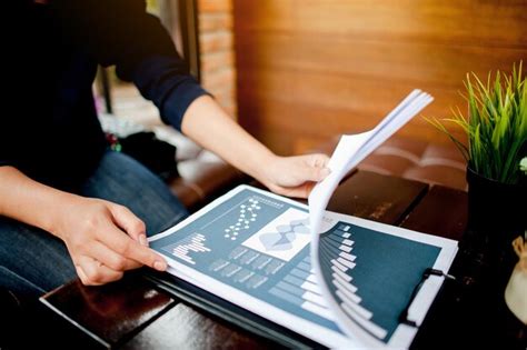 Premium Photo Cropped Hand Of Person Analyzing Graph On Table
