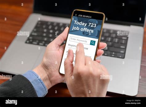 A Woman Is Looking Through Jobs Online Using A Mobile Job Search App On