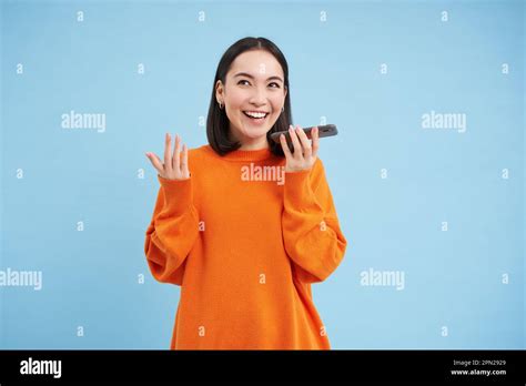 Cheerful Smiling Korean Woman Talk On Speakerphone Records Voice