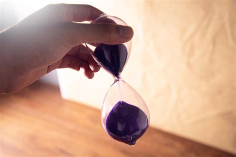 Premium Photo Man Hand Holding Hourglass