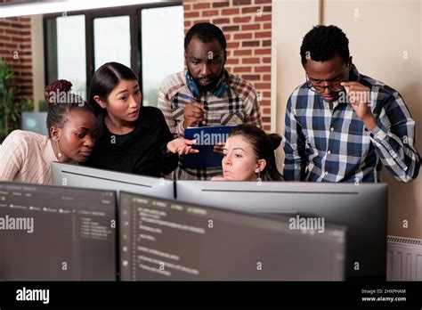 Informational Agency Multiracial Tech Engineers Programming Application While Using Computer