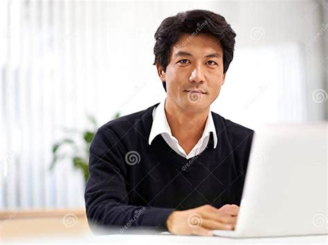 Hes A True Professional A Handsome Asian Businessman Working On His