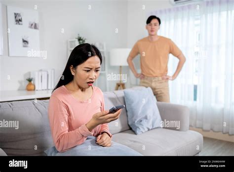 Shocked Jealous Asian Girlfriend Suspecting Infidelity By Reading Text