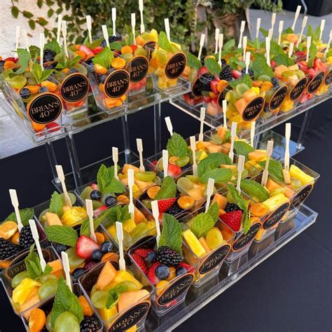 Several Trays Filled With Different Types Of Fruit On Top Of A Black