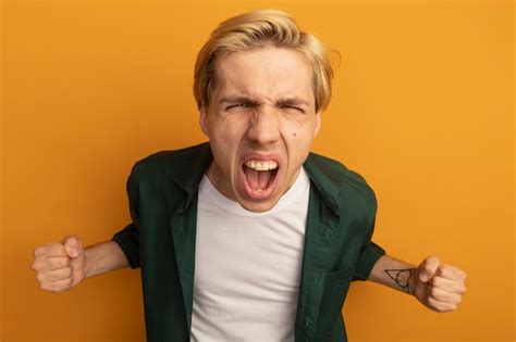 Free Photo Excited Young Blonde Guy Wearing Green T Shirt Showing Yes