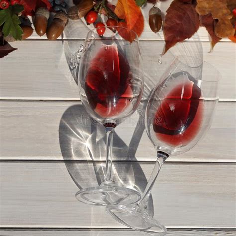 Two Glasses Of Red Wine On Wooden Background With Autumn Leaves Stock