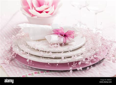Place Setting In Pink Tone With Small Present For The Guests Stock