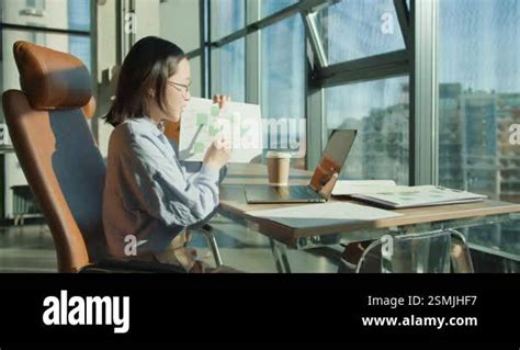 A Woman In Glasses Explains A Complex Data Flow Diagram While Pointing