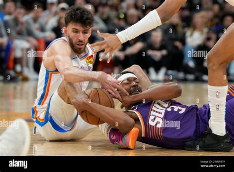 Oklahoma City Thunder forward Chet Holmgren, left, and Phoenix Suns guard Bradley Beal (3) fight ...