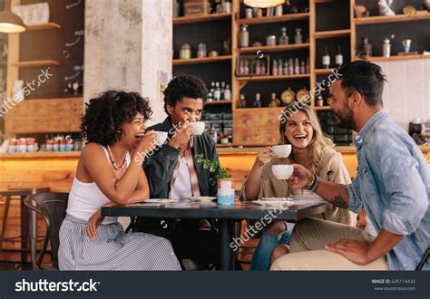 Diverse Group Of Friends Enjoying Some Coffee Together In A Restaurant