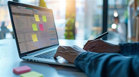 Business Developer Using Kanban Board Framework On Laptop Screen