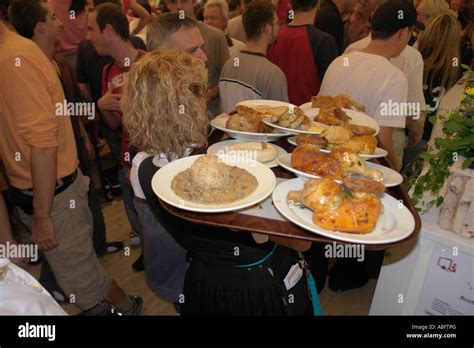 Server Waitress Carry Tray Of Roasted Chicken Or Roasted Meat Around In The Beer Tent At Munich
