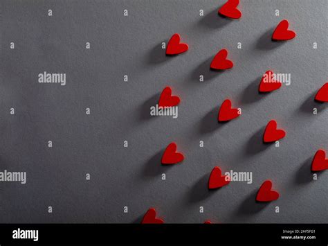 Overhead View Of Red Heart Shaped Decorations Arranged Over Gray