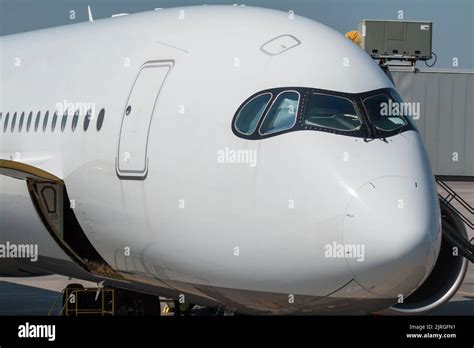 Close Up Of The Front Of The White Wide Body Passenger Aircraft At The