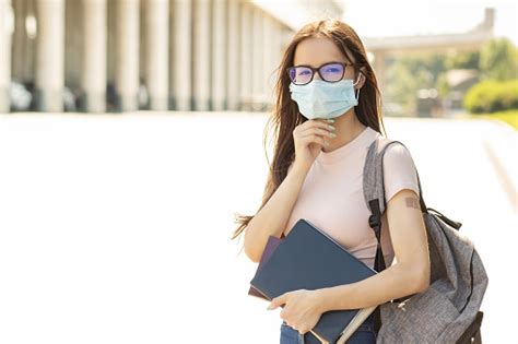 학교와 대학에서 가르치는 역학 규칙 학생 예방 접종 손에 의료 석고와 백신을받은 후 십대 소녀와 보호 마스크는 대학 근처에 서있다 16 17 살에 대한 스톡 사진 및 기타