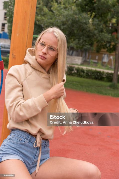Cheerful Attractive Blonde Fitness Girl Posing On Sports Ground Outside