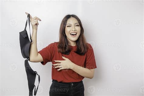 Woman Smiling And Holding A Bra Against White Background Concept Of