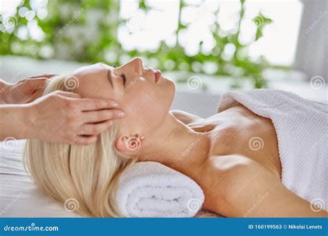 Beautiful Woman With Closed Eyes Getting A Massage In The Spa Salon