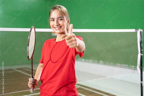 Beautiful Girl Badminton Player With Thumbs Up Holding Racket Stock