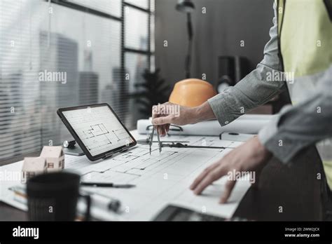 Architect Using Divider Compass Working On Blueprint House Planning