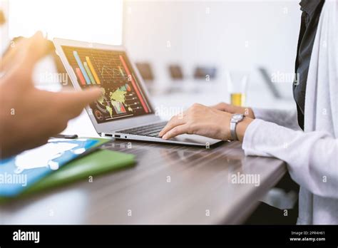 Closeup Businesswoman Hand Typing In Laptop Computer With Business Chart Company Information In