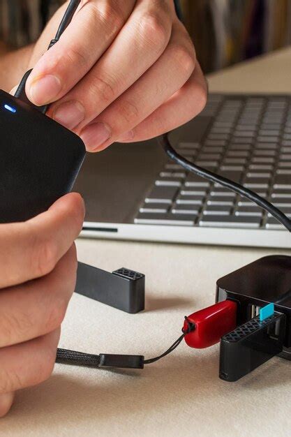Premium Photo Male Hand Connecting Hard Drive With Usb Cable To Laptop Computer And Usb