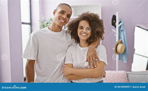 Confident Beautiful Couple Hugging And Smiling In Their Cozy Home