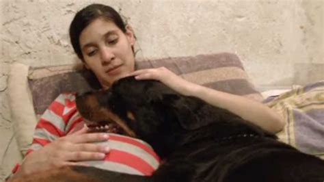 Woman Suckles Puppies