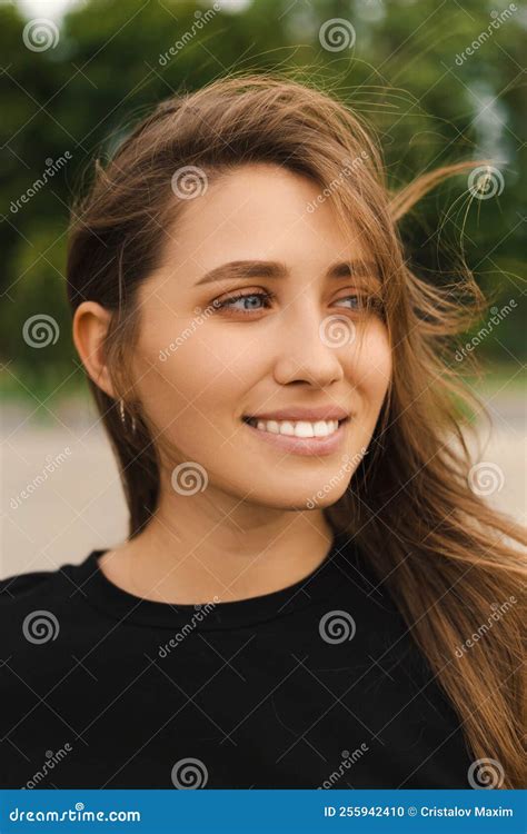 Vertical Close Up Portrait Of A Blonde Smiling Woman Over Natural
