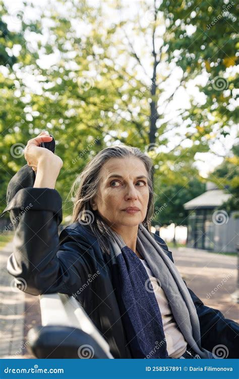 Beautiful Mature Woman In Autumn Park Flooded With Sunlight Stock Image