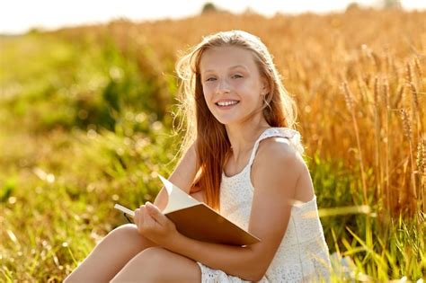 Premium Photo Smiling Girl Reading Diary On Cereal Field