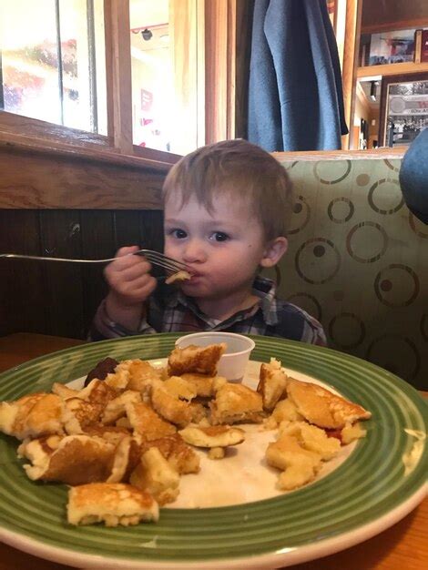 Premium Photo Portrait Of Boy Eating Bread At Home