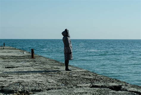 The Girl Is Sitting On The Seashore Girl Resting By The Sea A Woman